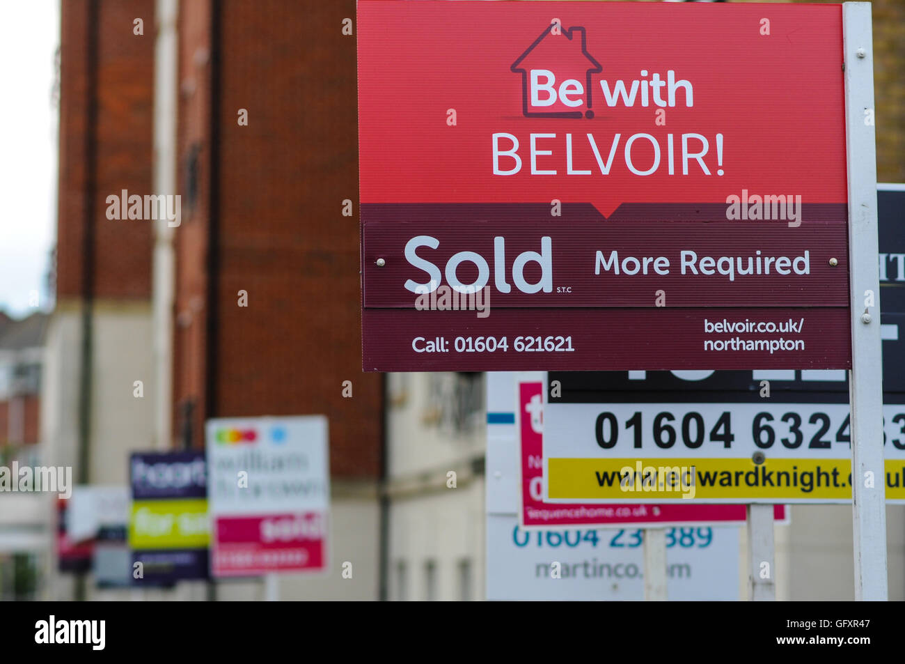 Estate agent signs houses for sale and rent Stock Photo - Alamy