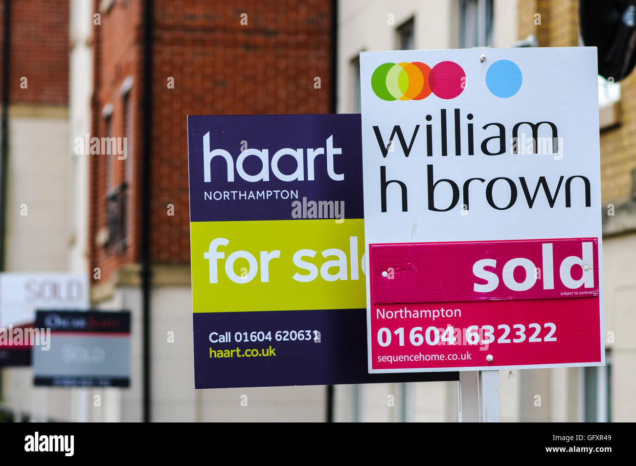 Estate agent signs houses for sale and rent Stock Photo - Alamy