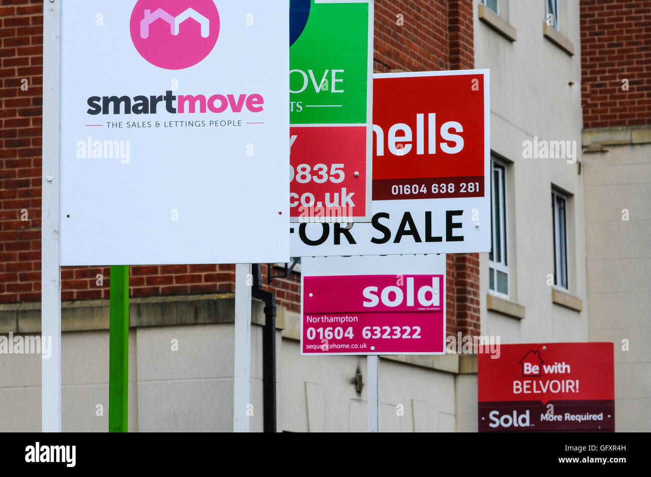 Estate agent signs houses for sale and rent Stock Photo - Alamy