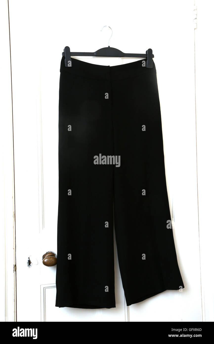 Black Trousers Hanging On Door Stock Photo - Alamy