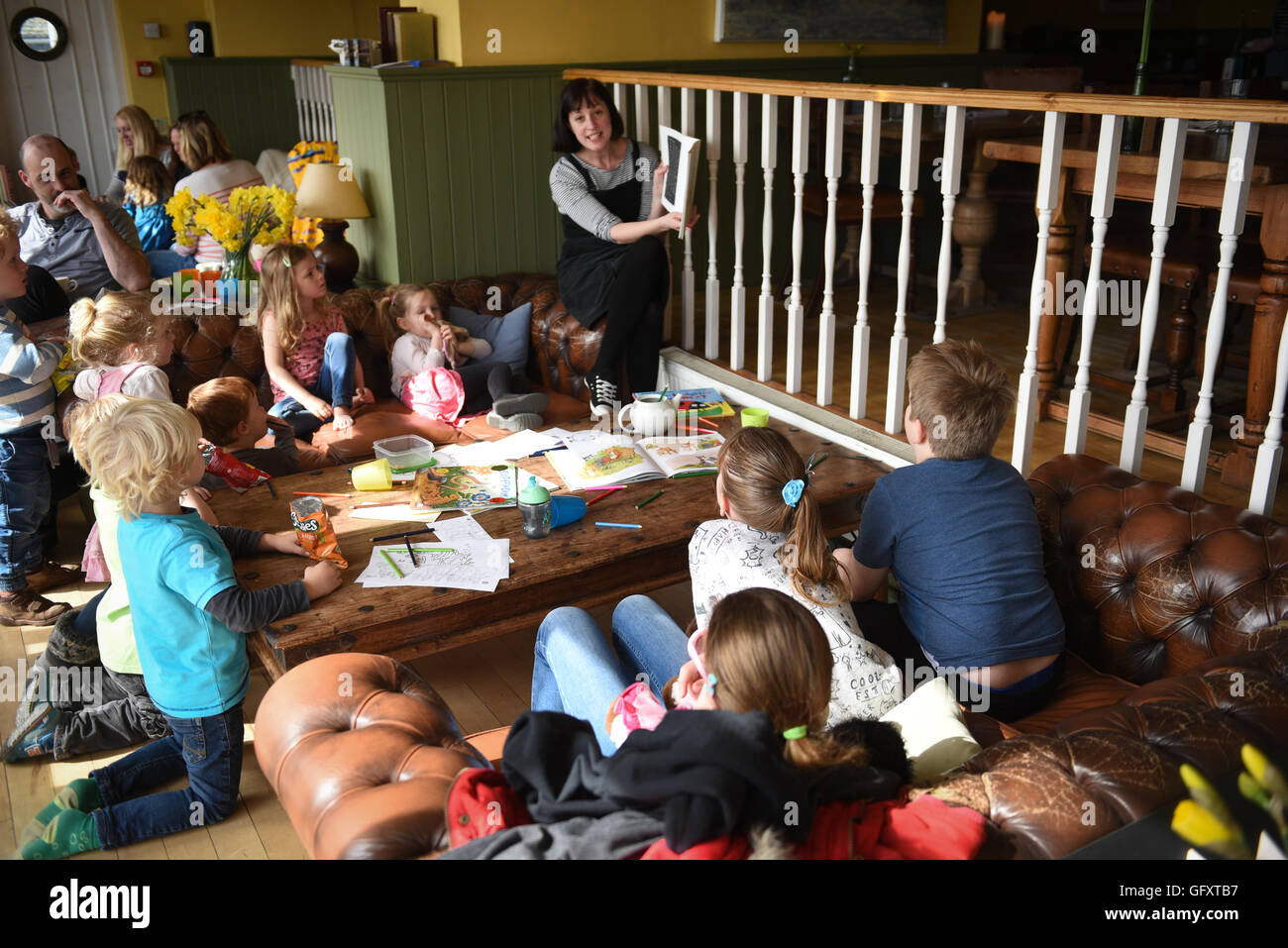 woman storytelling to children at a pub in Cornwall Stock Photo - Alamy