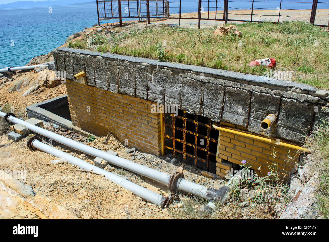 Old devastated facility on the seashore Stock Photo - Alamy