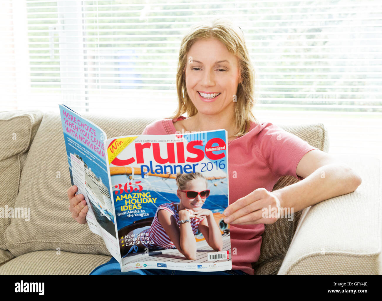 woman reading holiday magazine brochure Stock Photo - Alamy