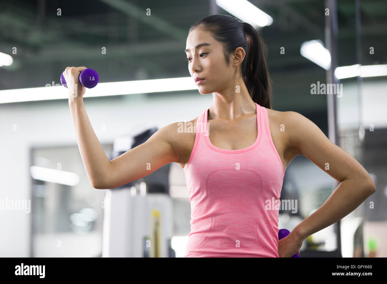 Young Chinese woman exercising at gym Stock Photo - Alamy