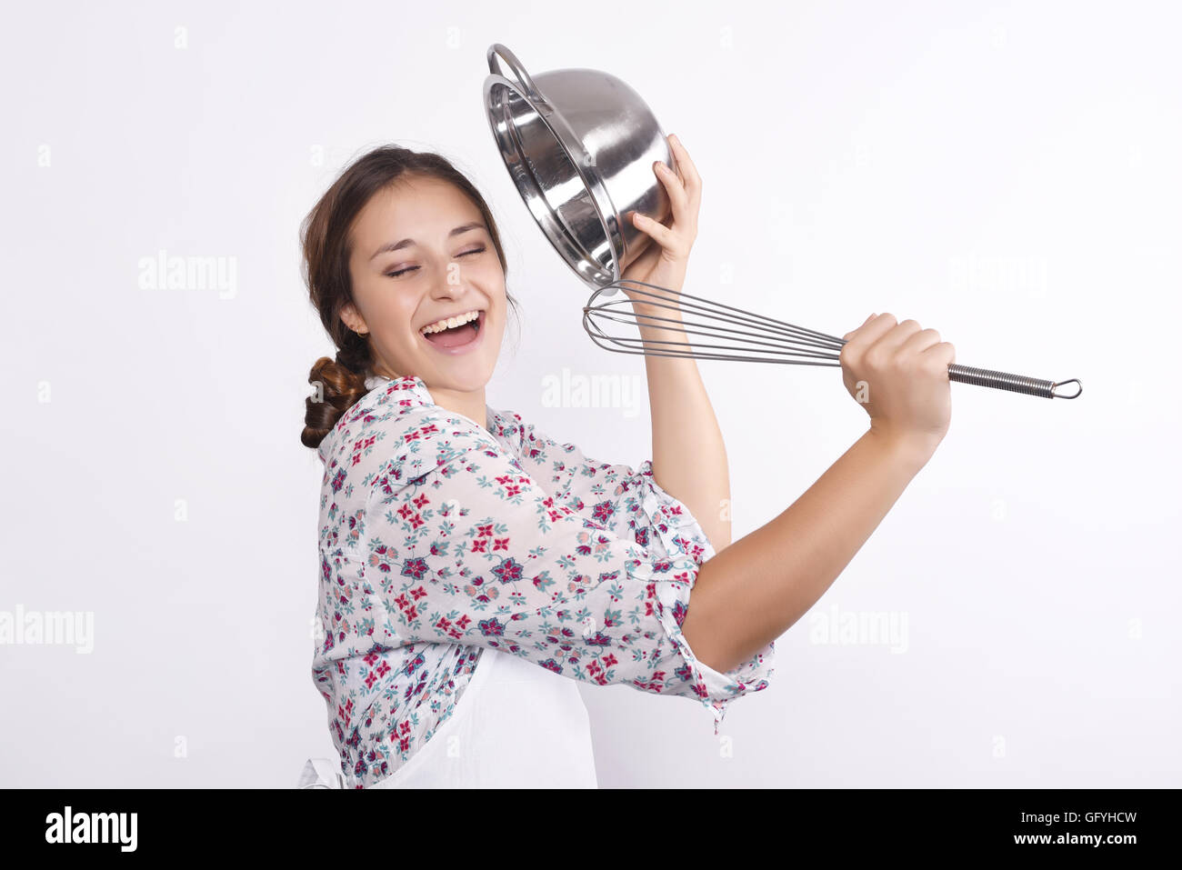 Portrait of young beautiful chef having fun. Isolated white background ...