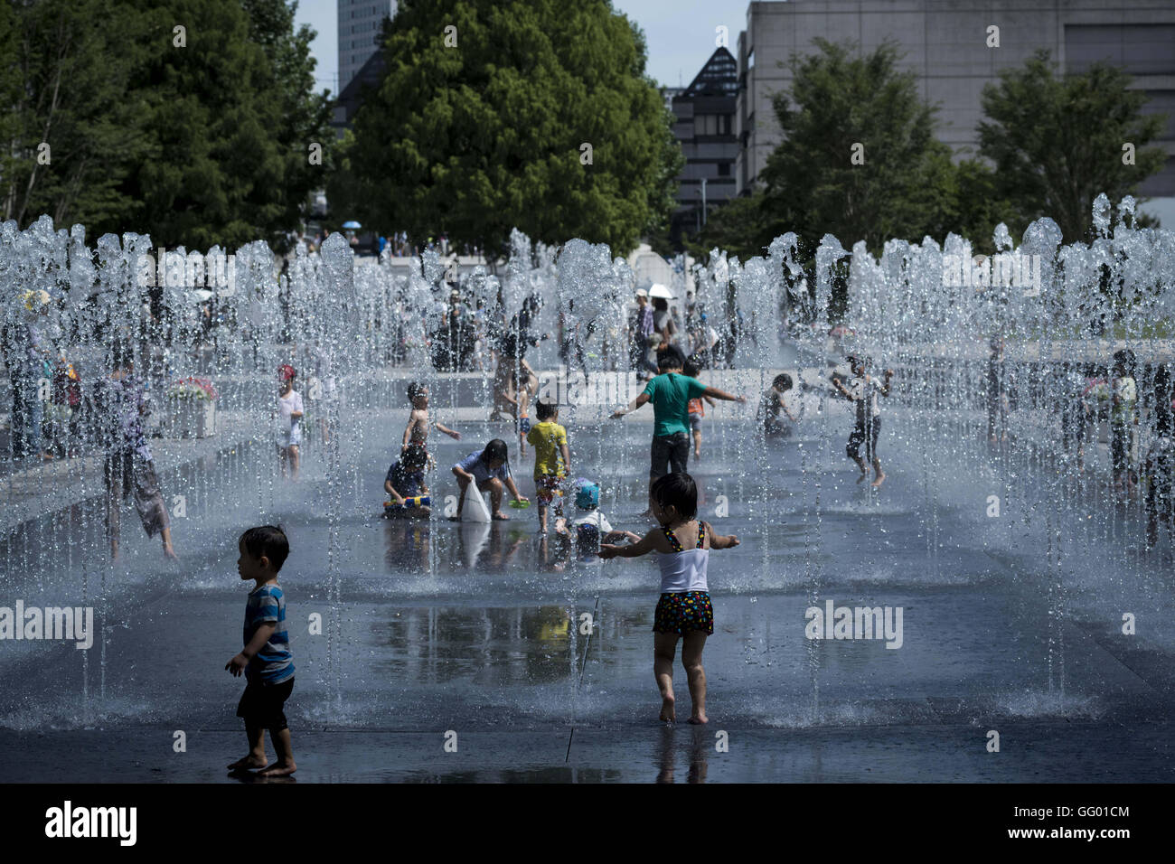Children playing water jets hi-res stock photography and images - Alamy