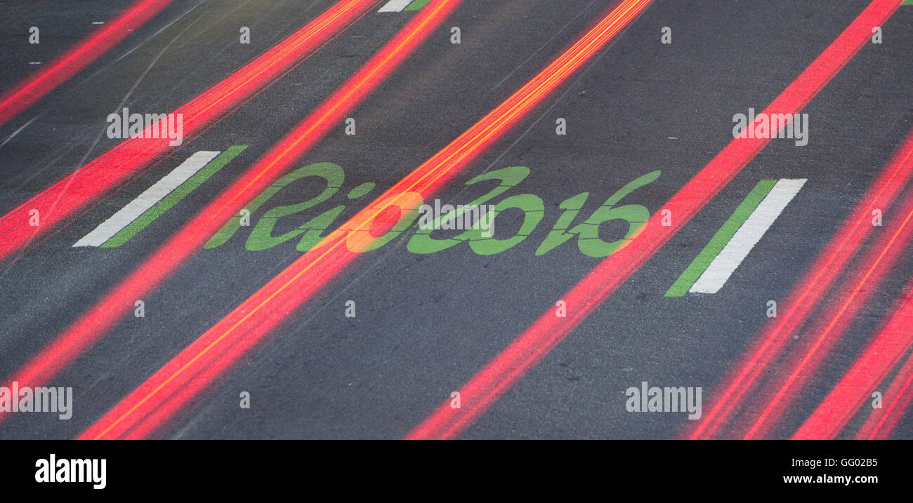 A photo taken with a slow shutter speed shows cars leaving light trails ...