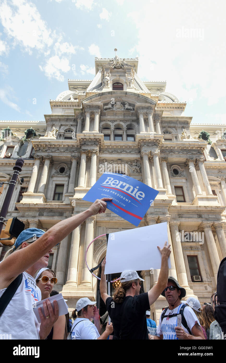 A woman holds her Bernie Sanders for President sign at the protest ...