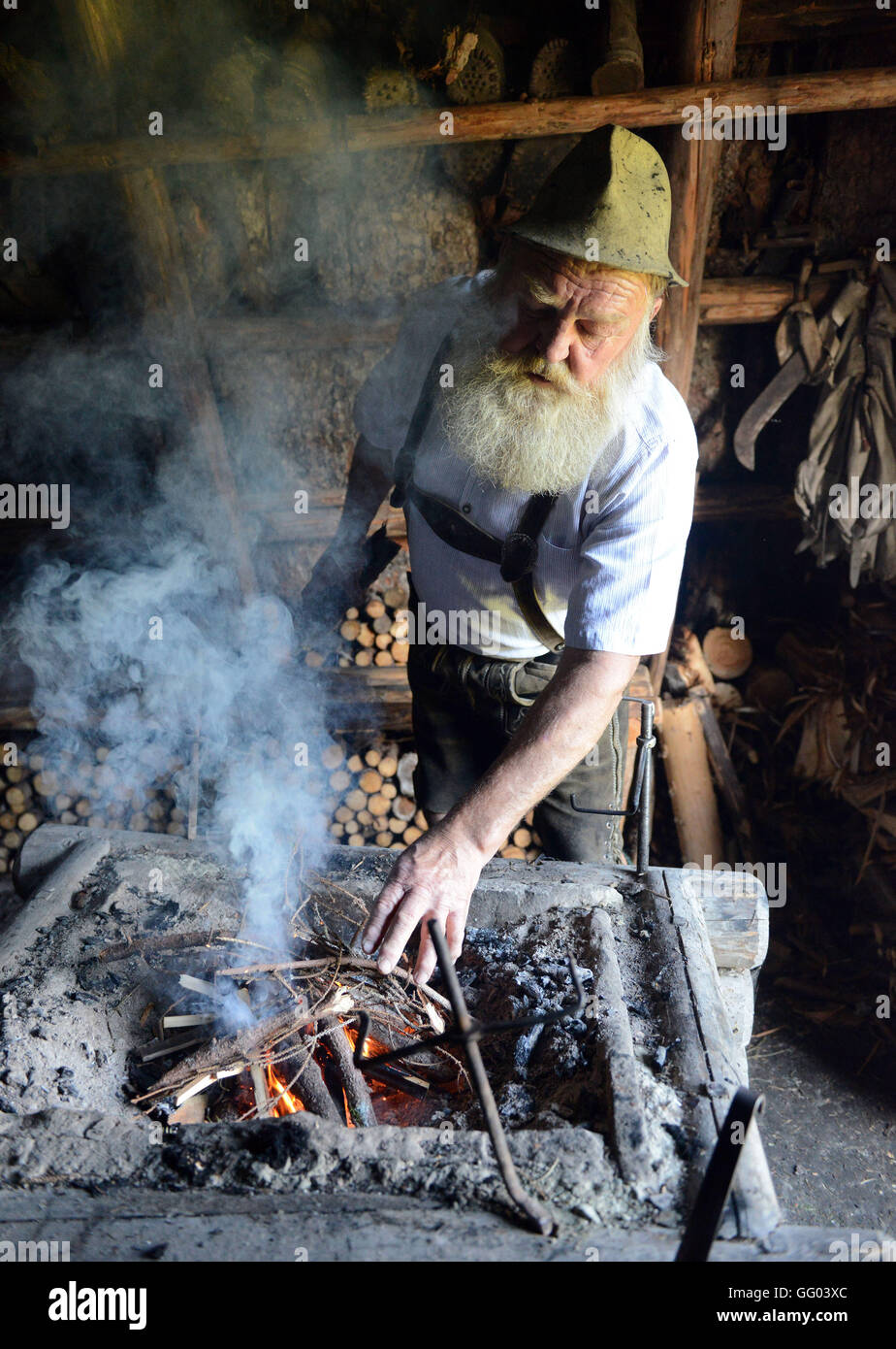 Bearded man Fritz Sendlhofer makes fire in leather pants and a ...
