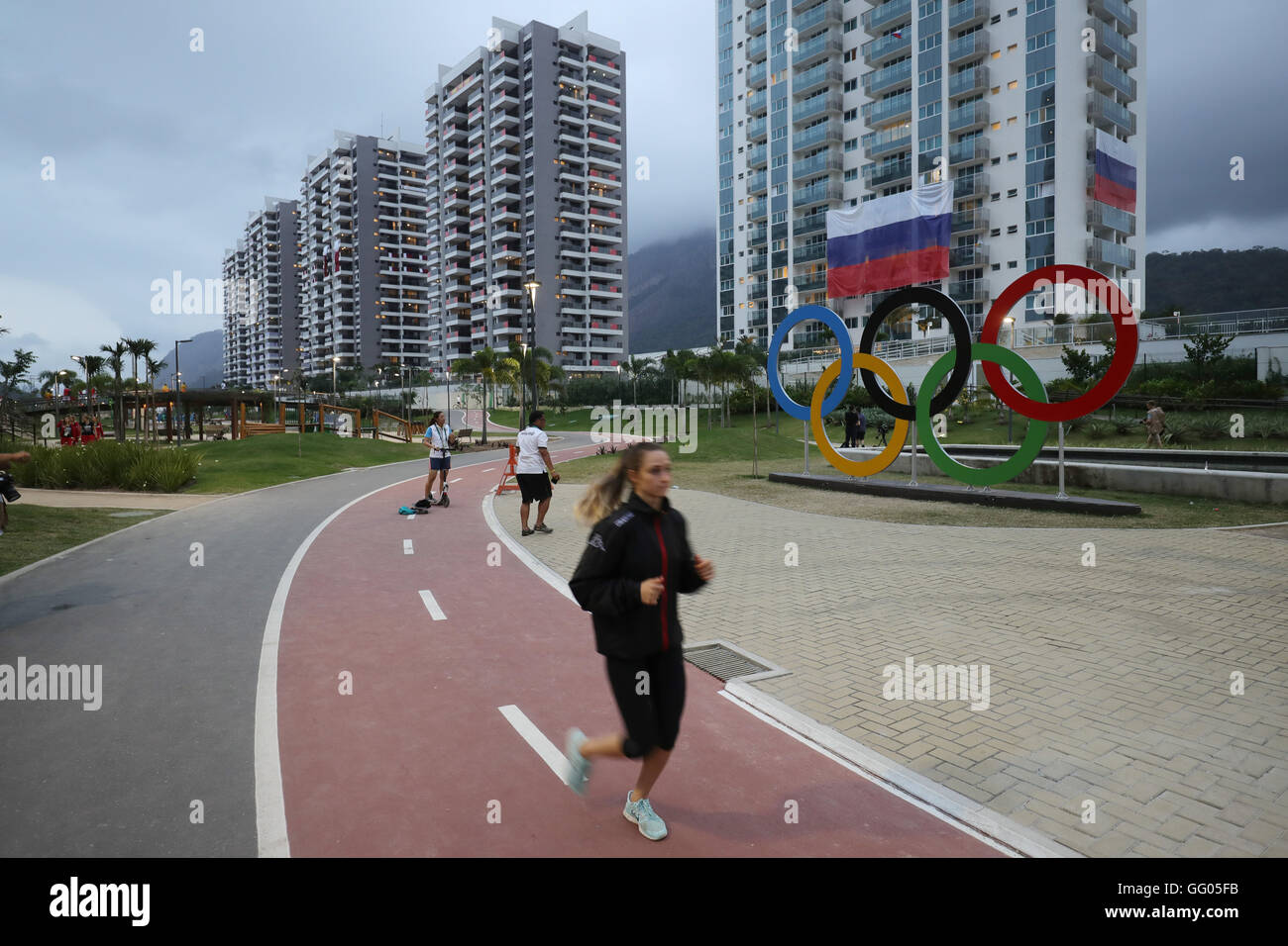Rio de Janeiro, Brazil. 2nd Aug, 2016. An athlete runs past the Olympic ...