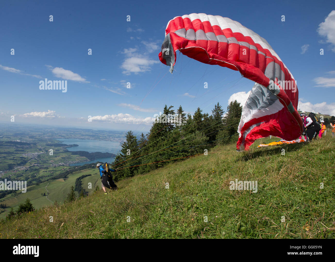 Geneva. 1st Aug, 2016. A paragliding fan prepares to fly on Rigi ...