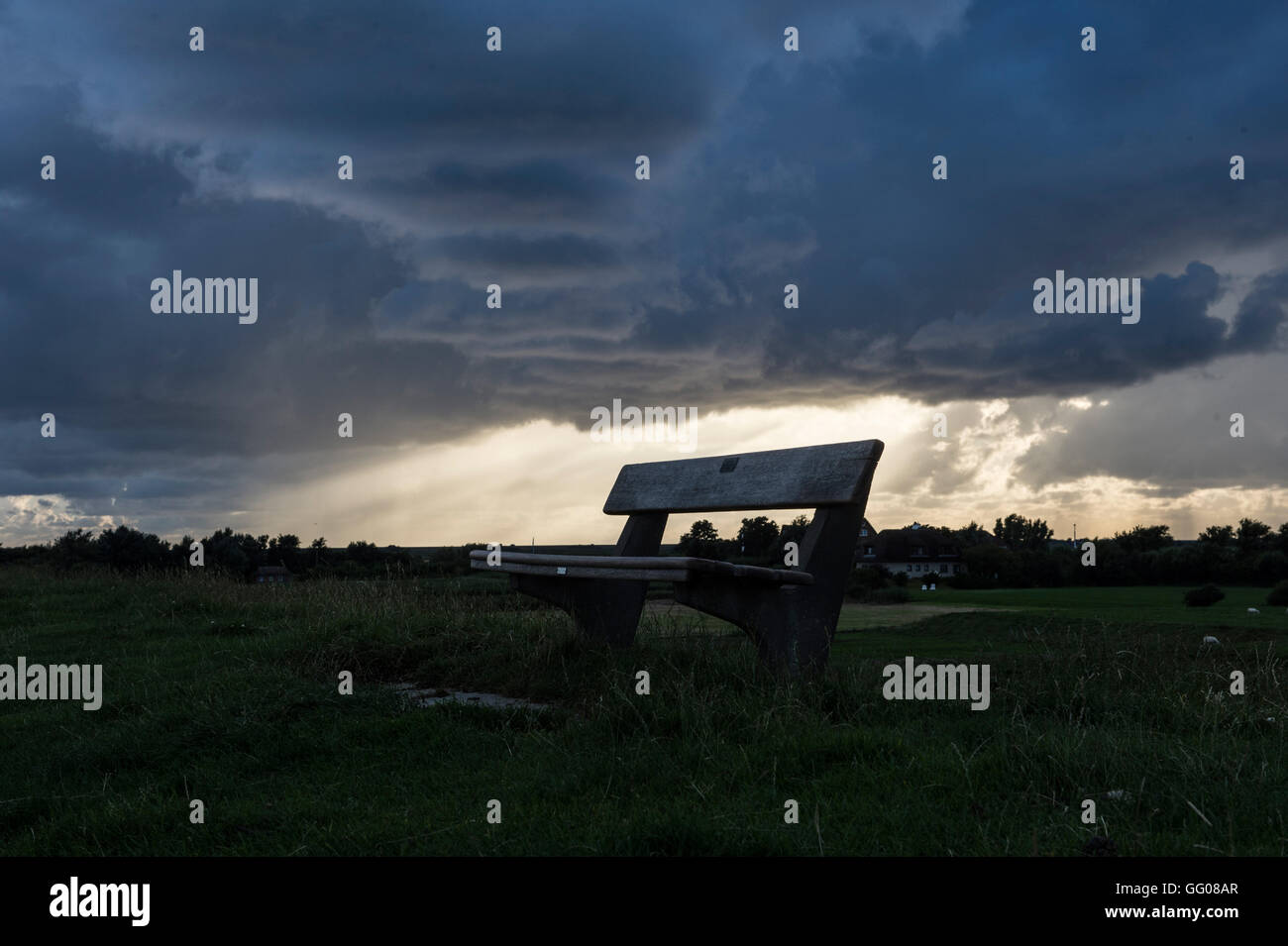 Pellworm, Germany. 02nd Aug, 2016. A bench contrasts with the ...