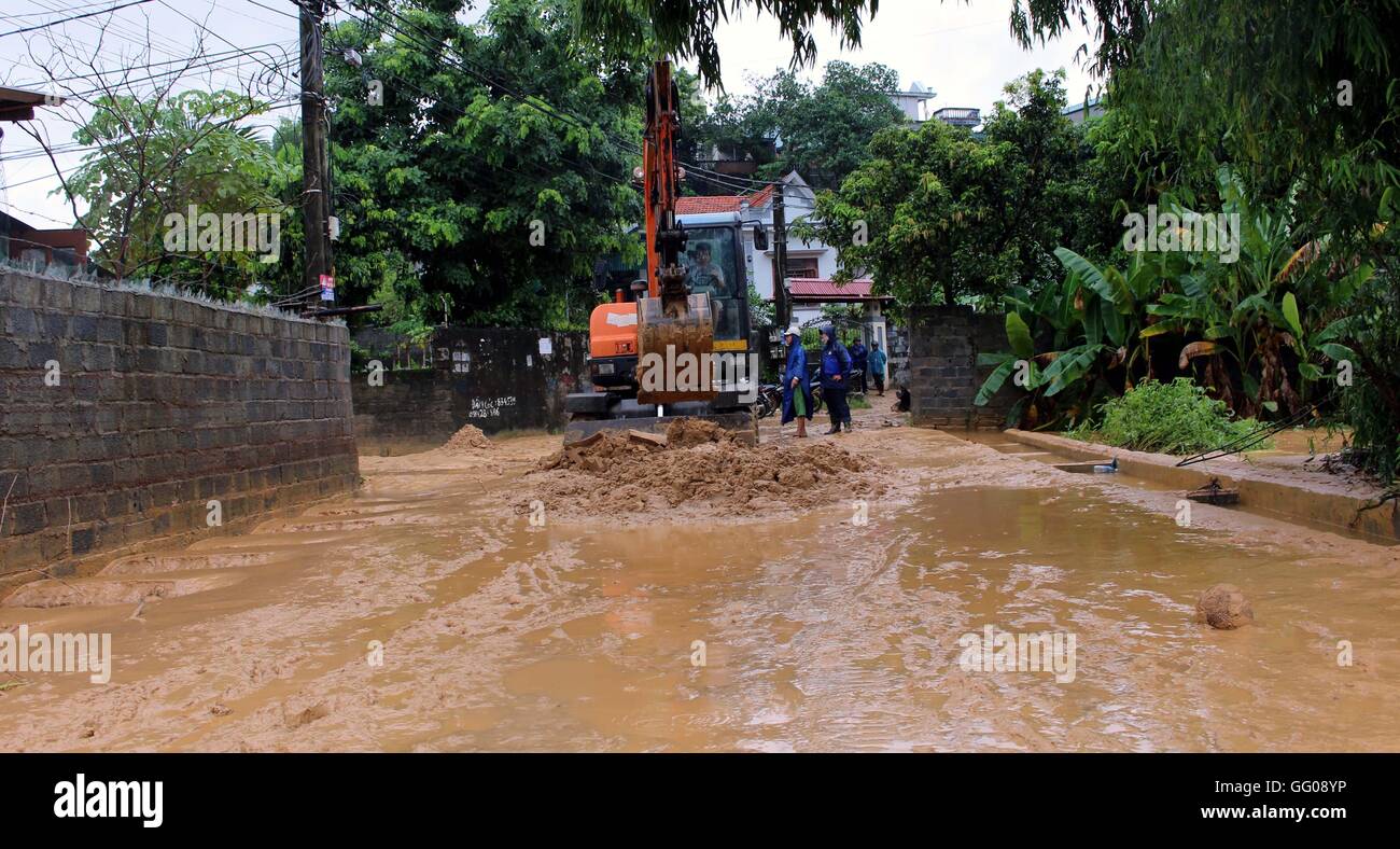 Hanoi, Vietnam. 3rd Aug, 2016. Workers clean up mud on a road in Ha ...