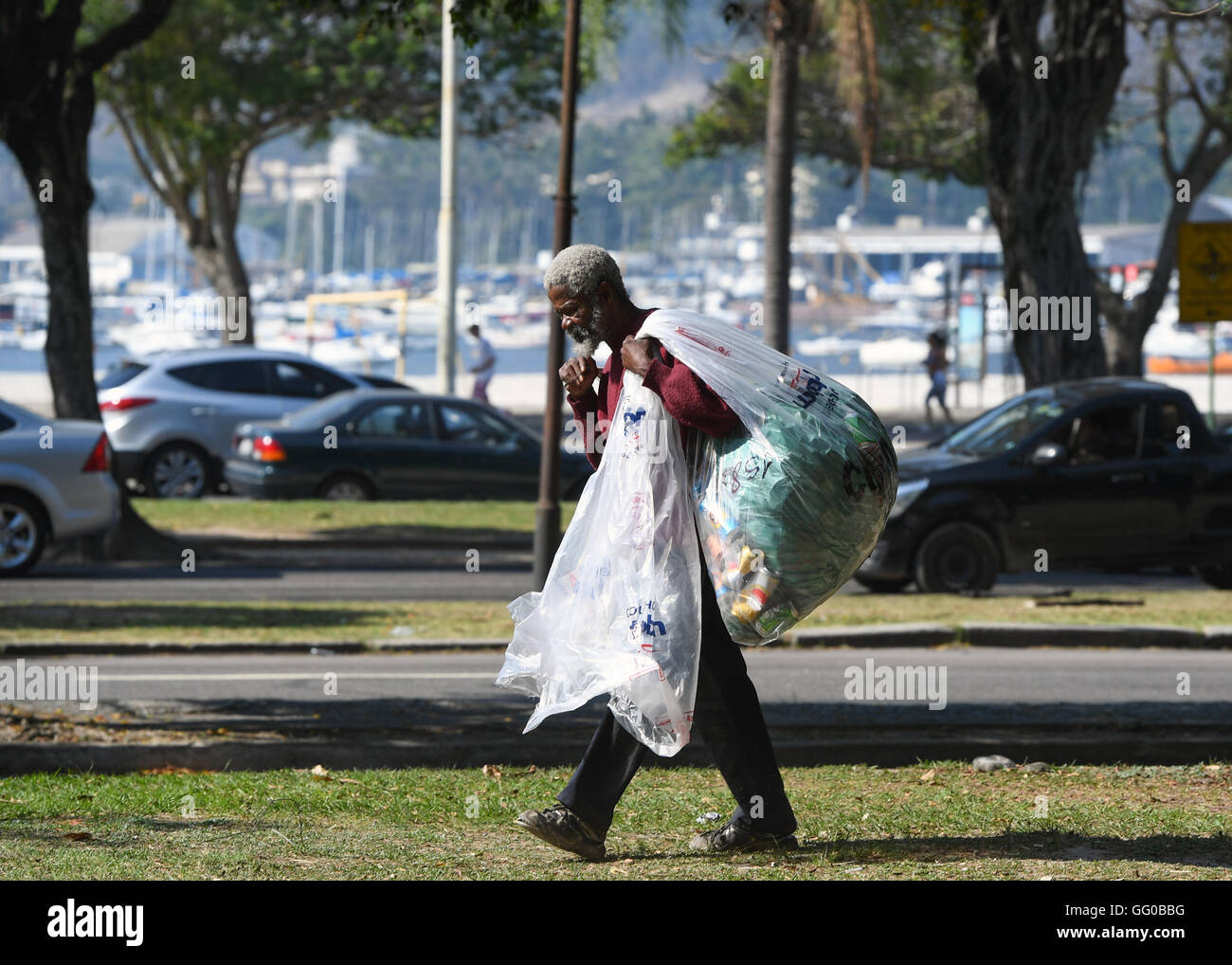 Rio de Janeiro, Brazil. 2nd Aug, 2016. A rubbish man walks prior to the ...