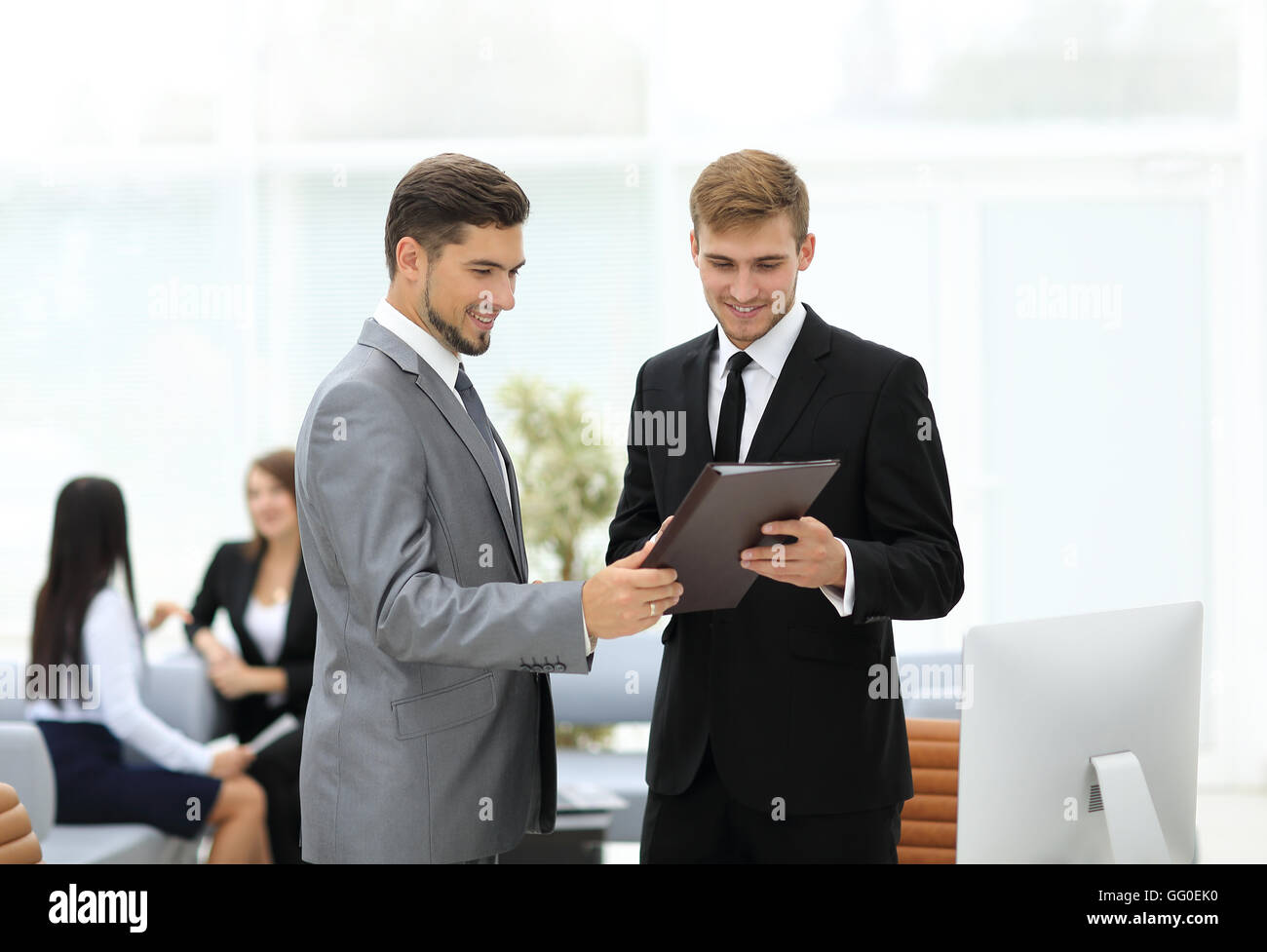 Two successful business partners discussing documents and ideas Stock ...