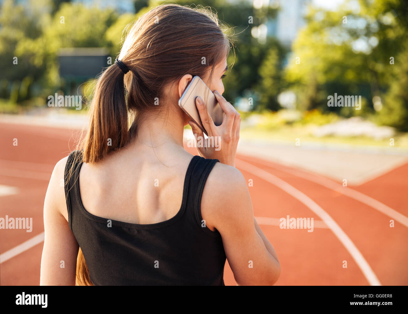 Woman runner talking phone hi-res stock photography and images - Alamy