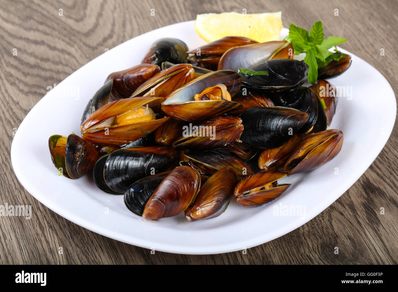 Boiled mussels with parsley on the wood background Stock Photo - Alamy