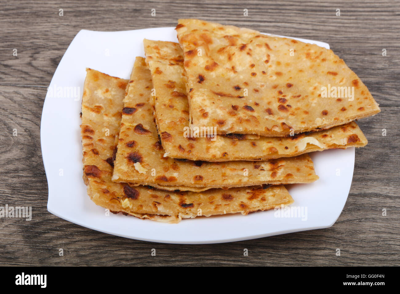 Indian bread roti on the plate in wood background Stock Photo - Alamy