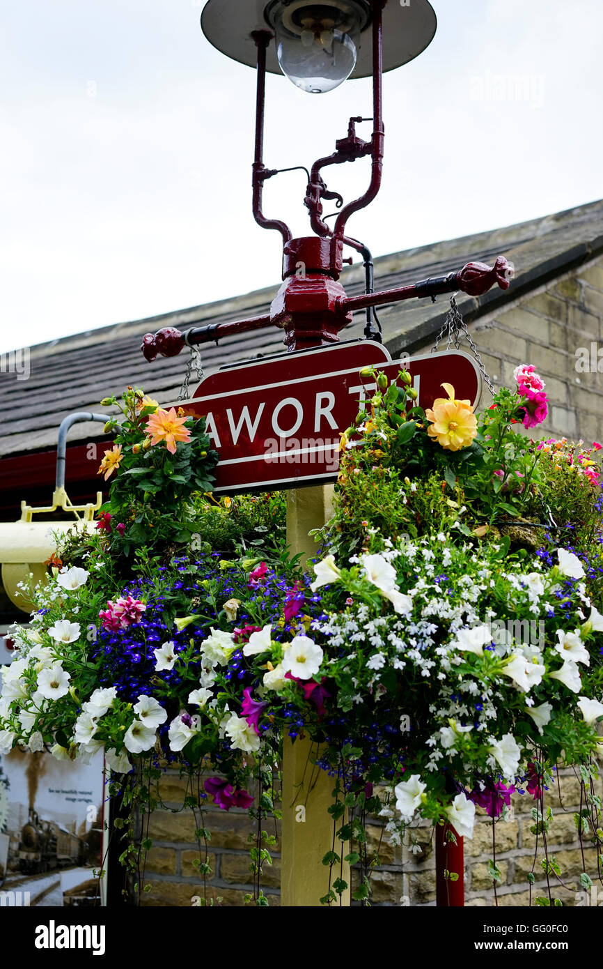 Hanging Flower Baskets on a vintage sign and lamp at Haworth Railway ...