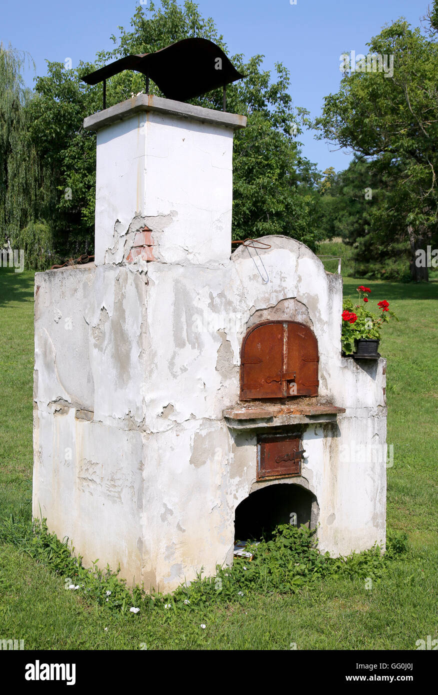 Rustic hundred years old hungarian furnace against green natural ...