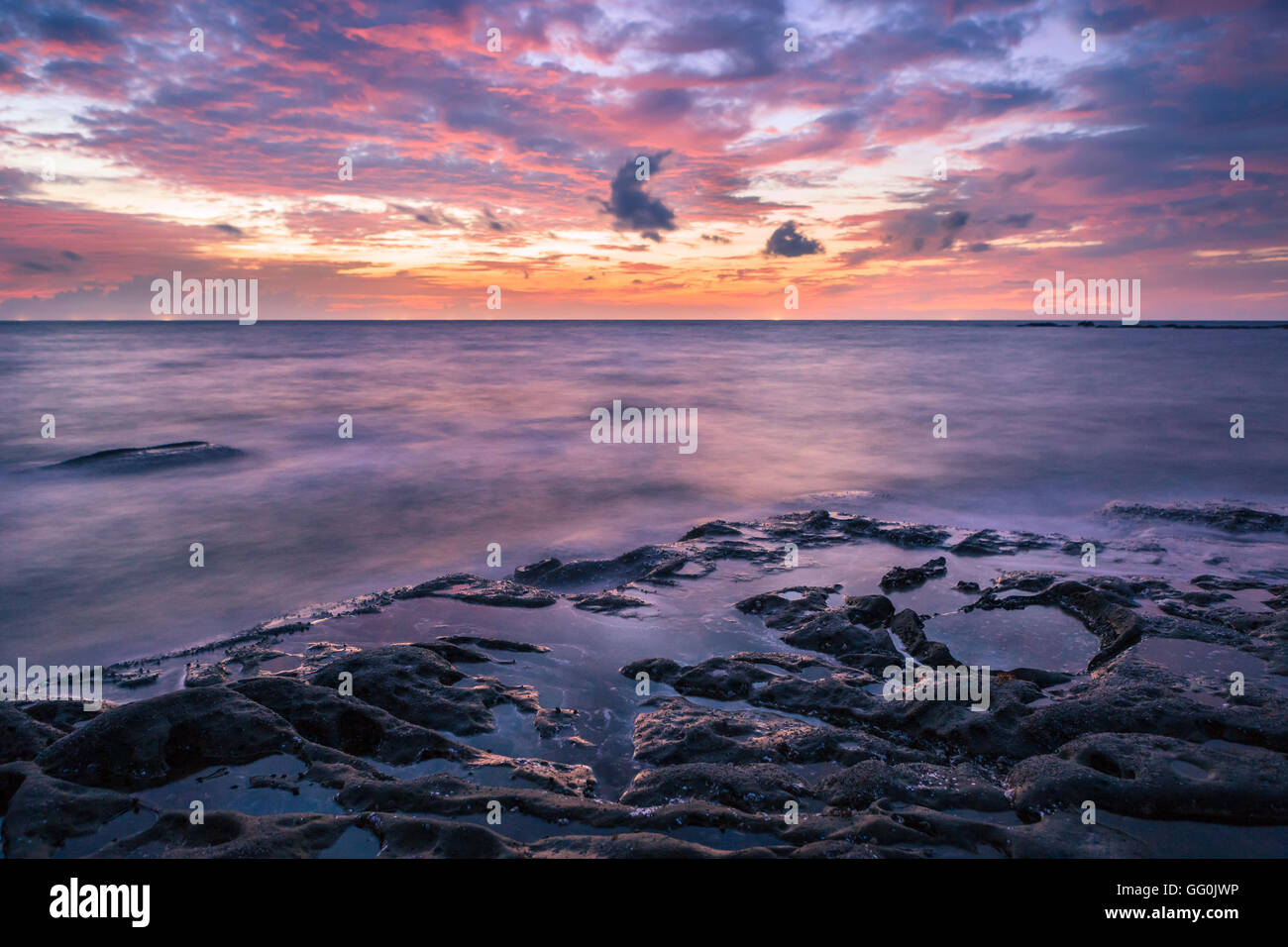 Long exposure sea and rocks at twilight Stock Photo - Alamy