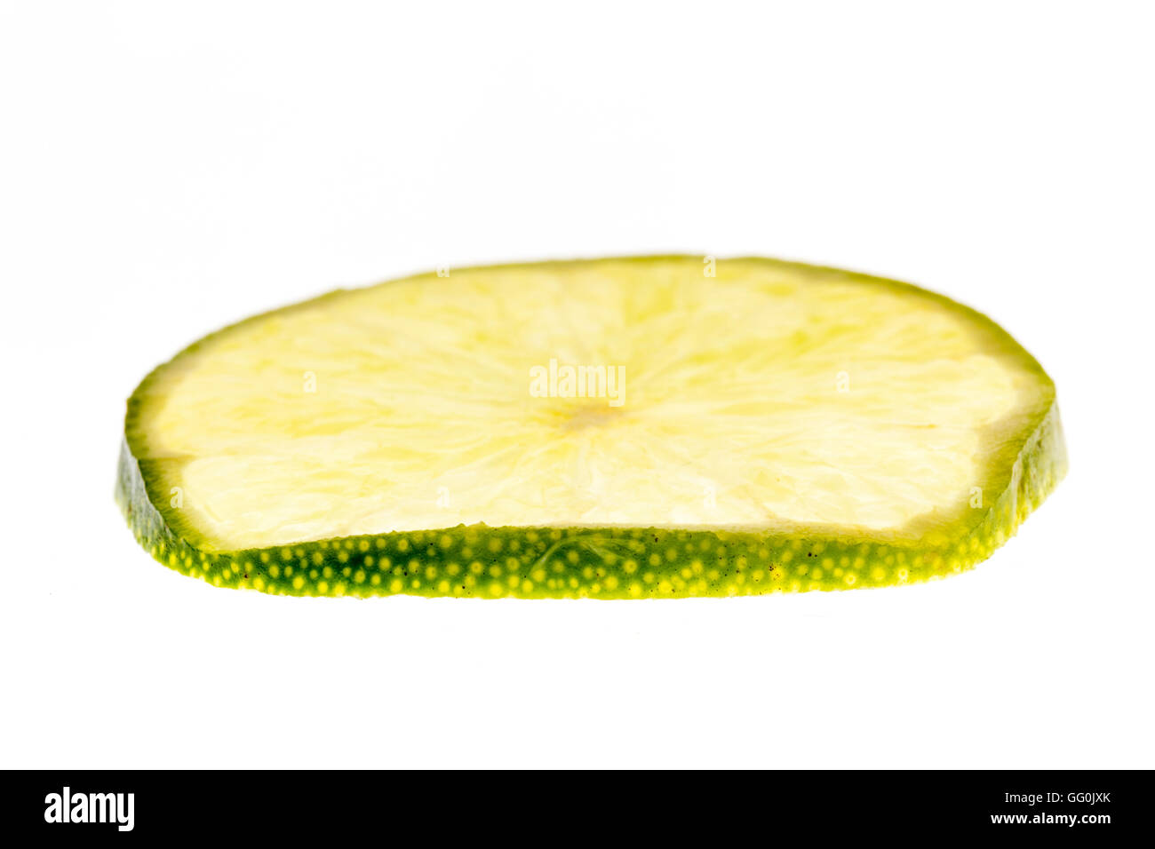 Lime fruit. Single slice of lime fruit on plain white background. Back ...