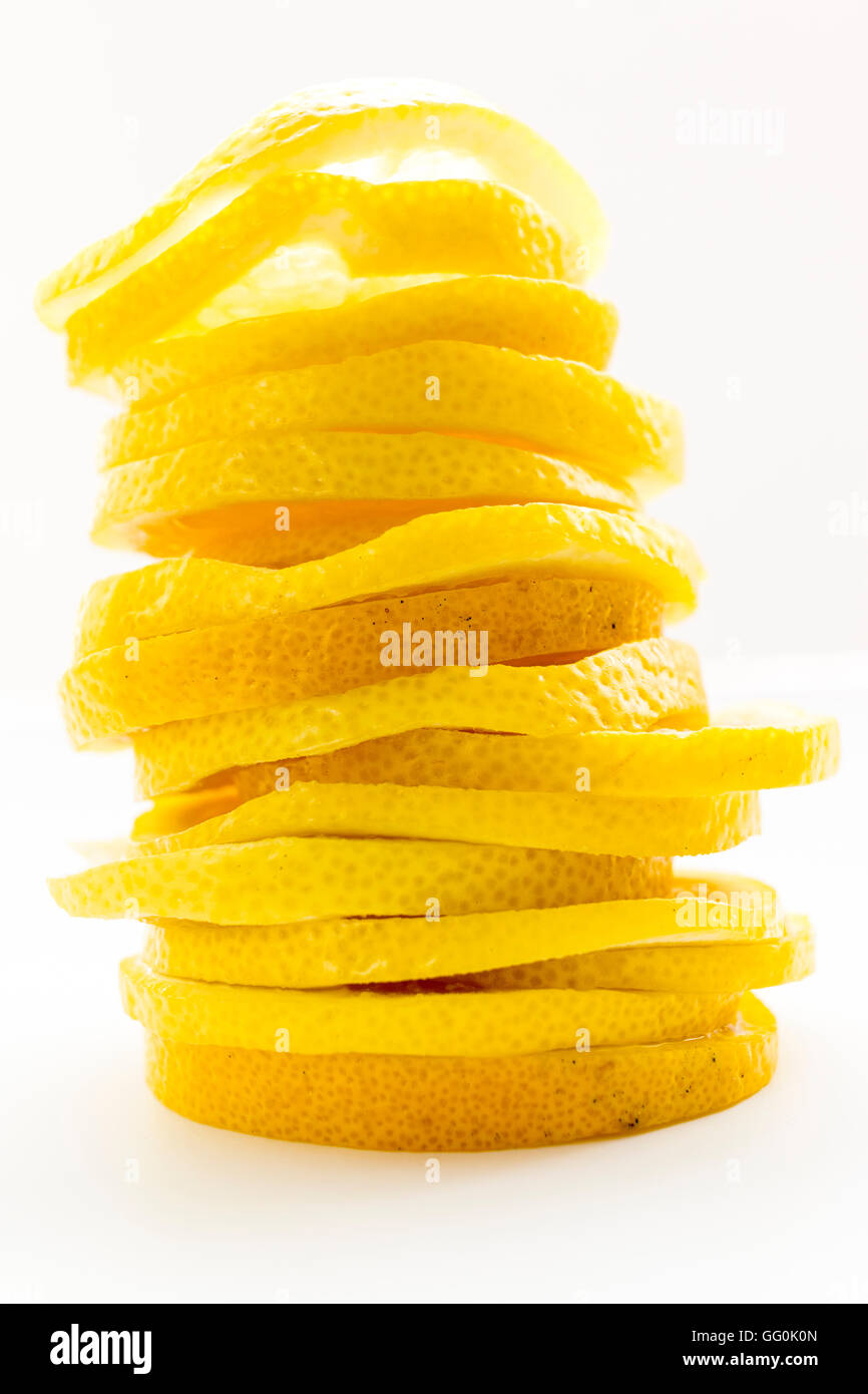 Lemon, fruit. Slices of lemon stacked on top of each other on plain ...