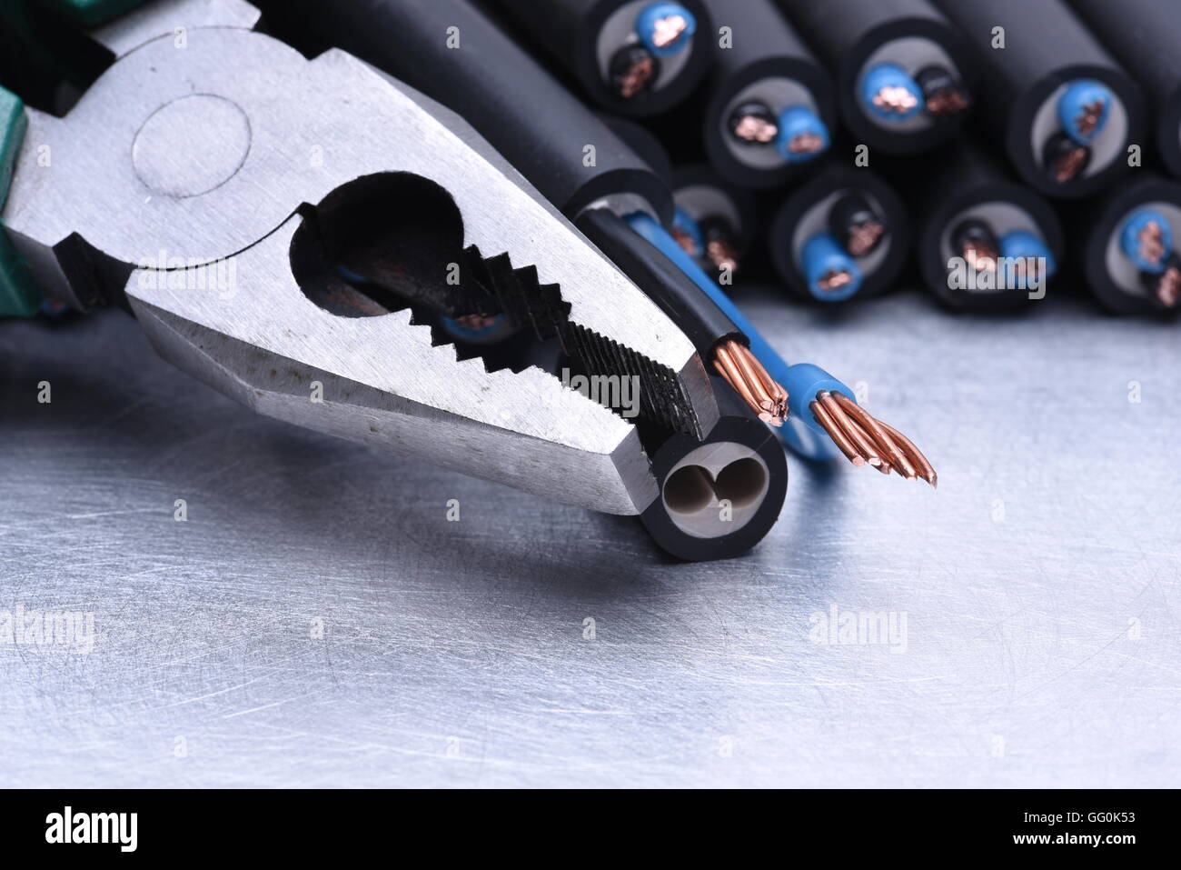 Electrician tool pliers and cables closeup Stock Photo - Alamy