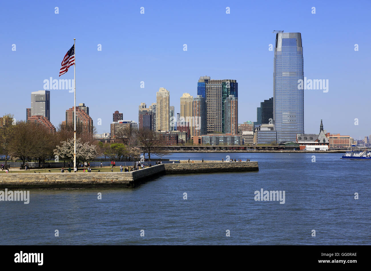 Liberty Island with Jersey City skyline and Goldman Sachs Tower in the ...