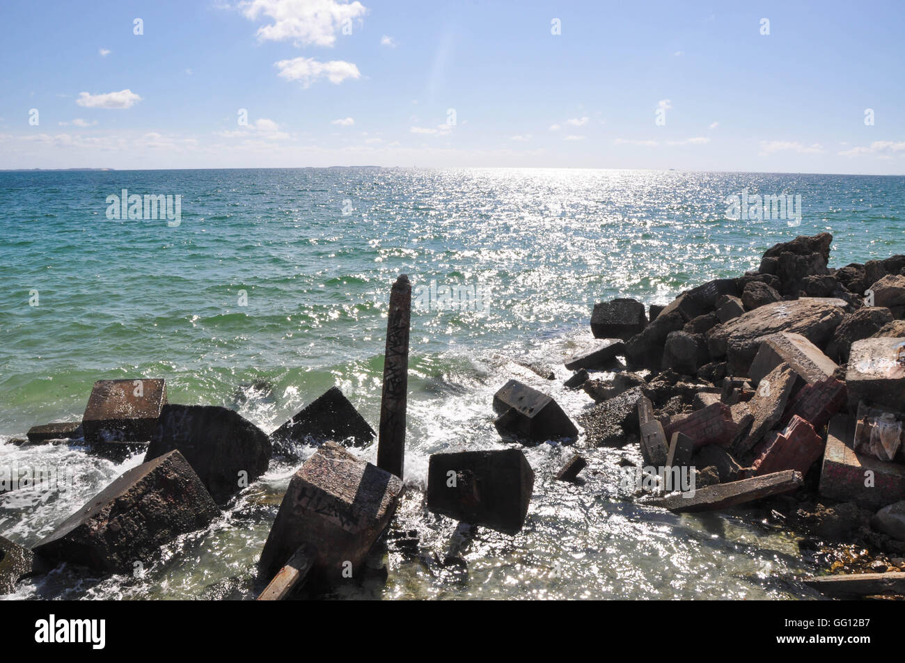 Concrete square ecology blocks and metal beams as breakwater in the ...