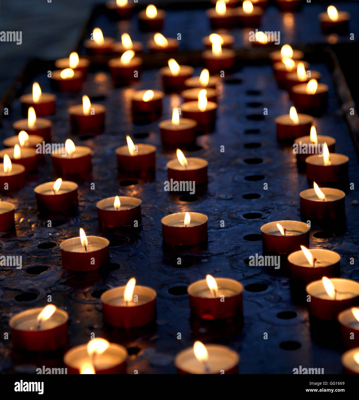many candles in a church for the prayers of the faithful with flame ...