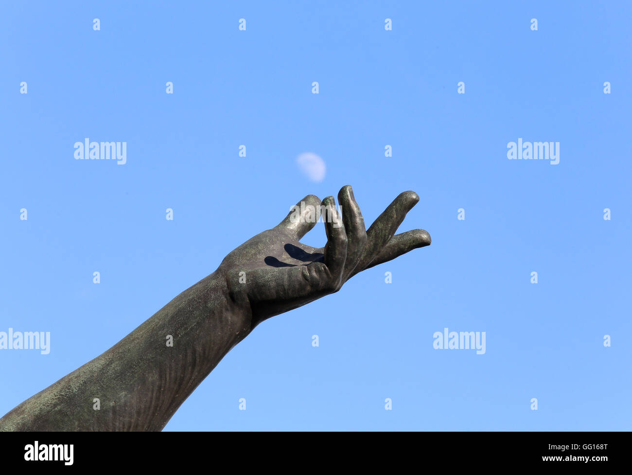 hand of statue trying to catch the white moon Stock Photo - Alamy