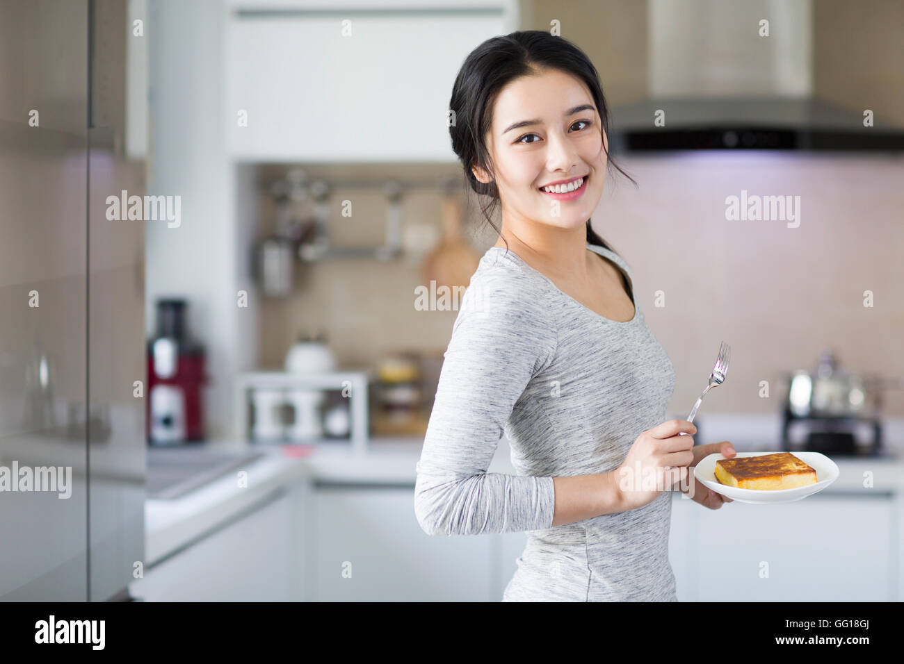 Young Chinese woman eating breakfast at home Stock Photo - Alamy