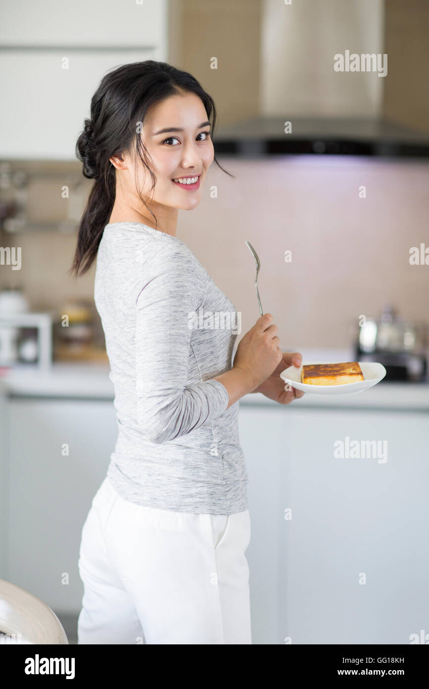 Young Chinese woman eating breakfast at home Stock Photo - Alamy