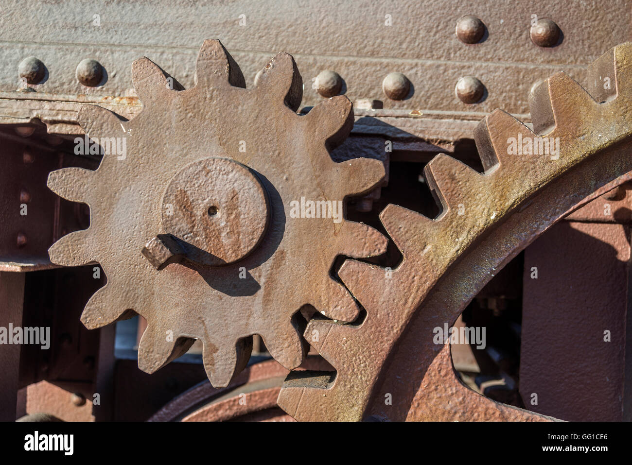 copper colored gears inserting in a big machine Stock Photo - Alamy