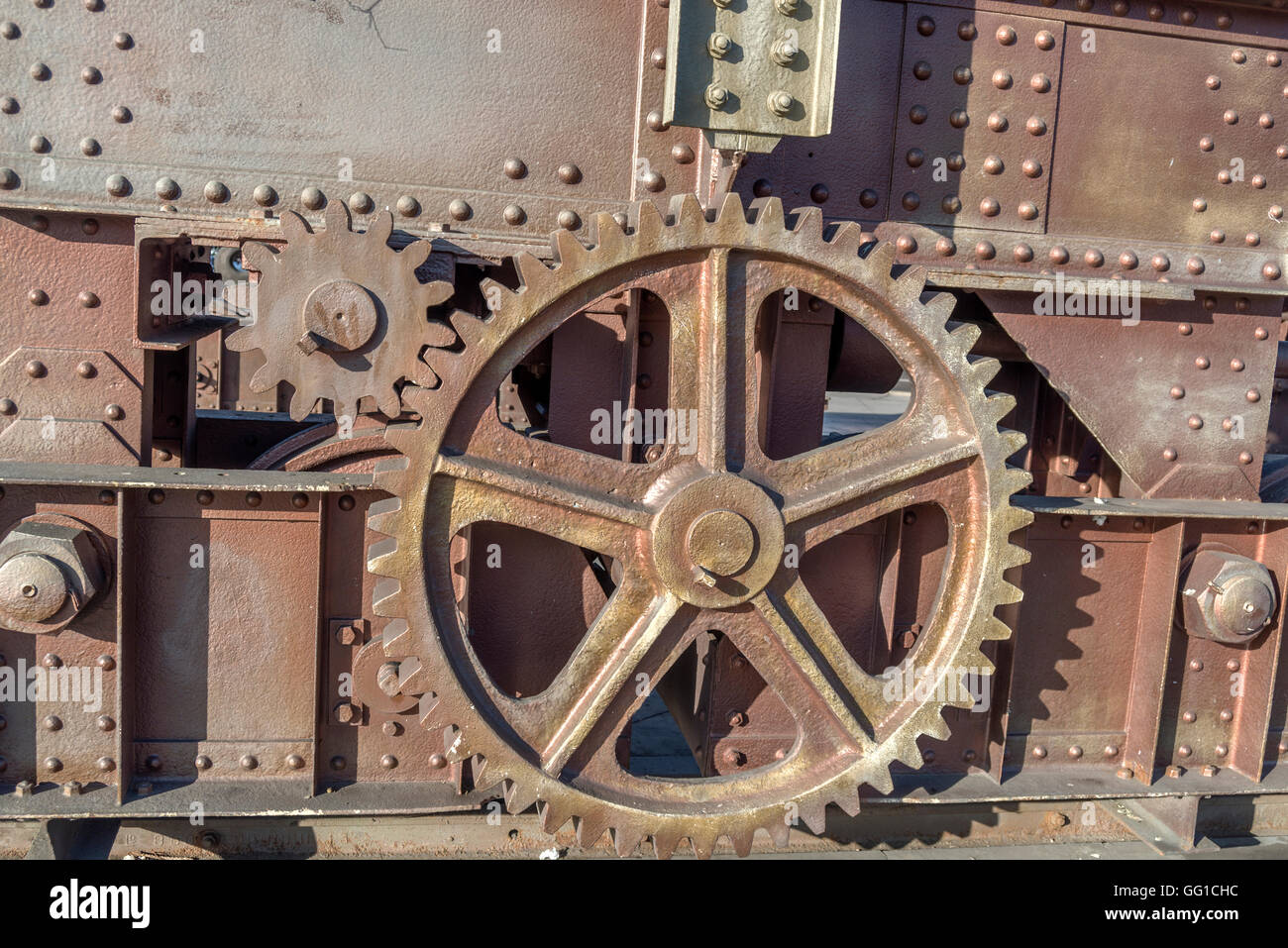 copper colored gears inserting in a big machine Stock Photo - Alamy