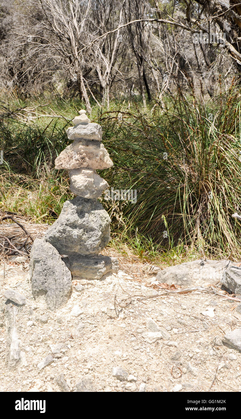 Conical pile of rocks, cairns, in a wetland nature setting at Lake ...