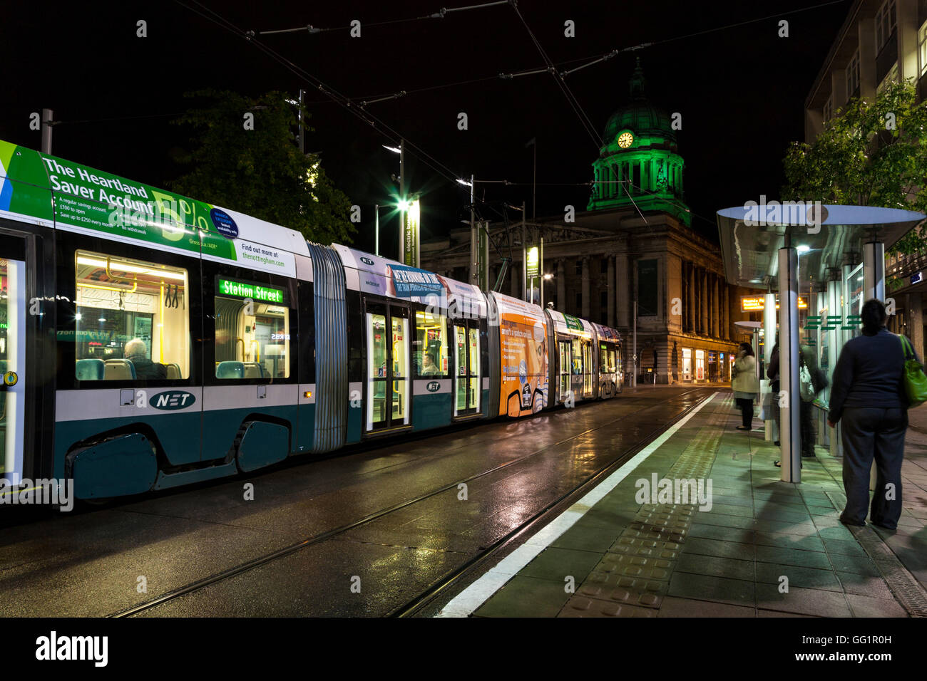 Nottingham tram in Nottingham city centre at night with the Council ...
