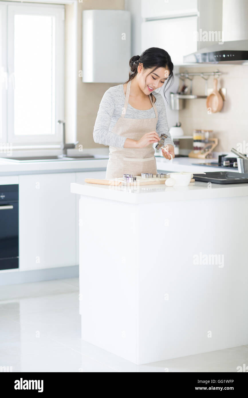 Young Chinese woman making cookies in kitchen Stock Photo - Alamy