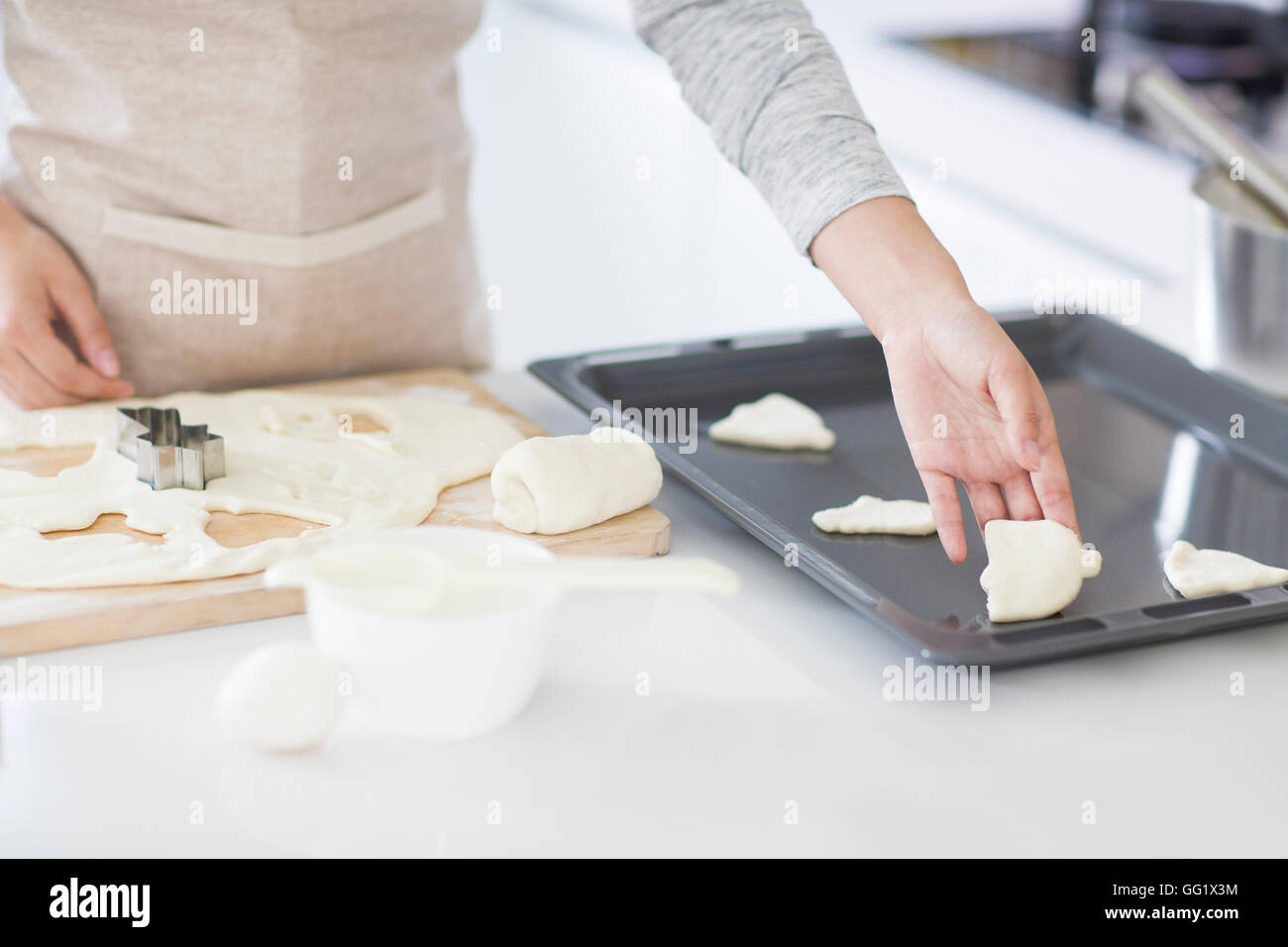 Young Chinese woman making cookies in kitchen Stock Photo - Alamy