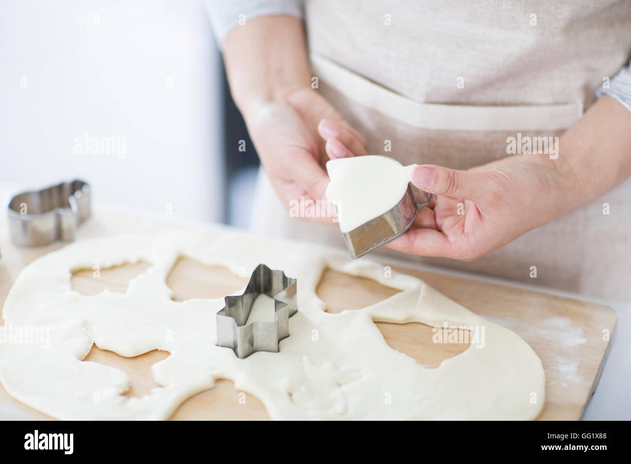 Young Chinese woman making cookies in kitchen Stock Photo - Alamy