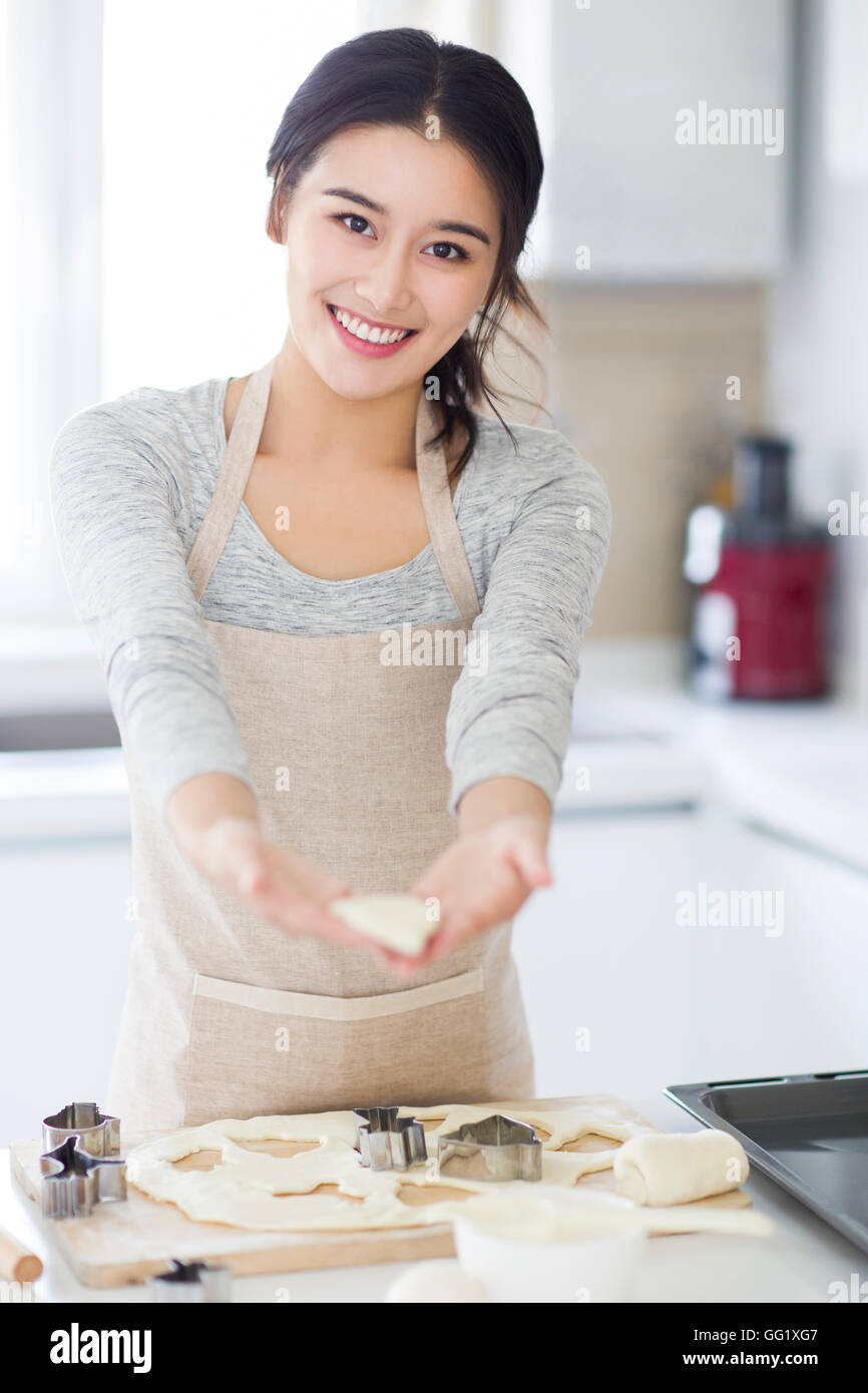 Young Chinese woman making cookies in kitchen Stock Photo - Alamy
