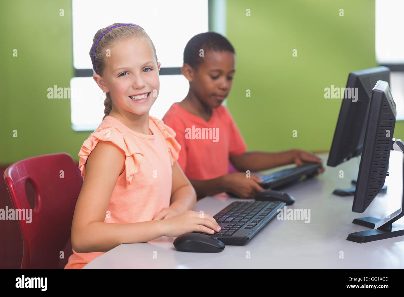 School kids using computer in classroom Stock Photo - Alamy