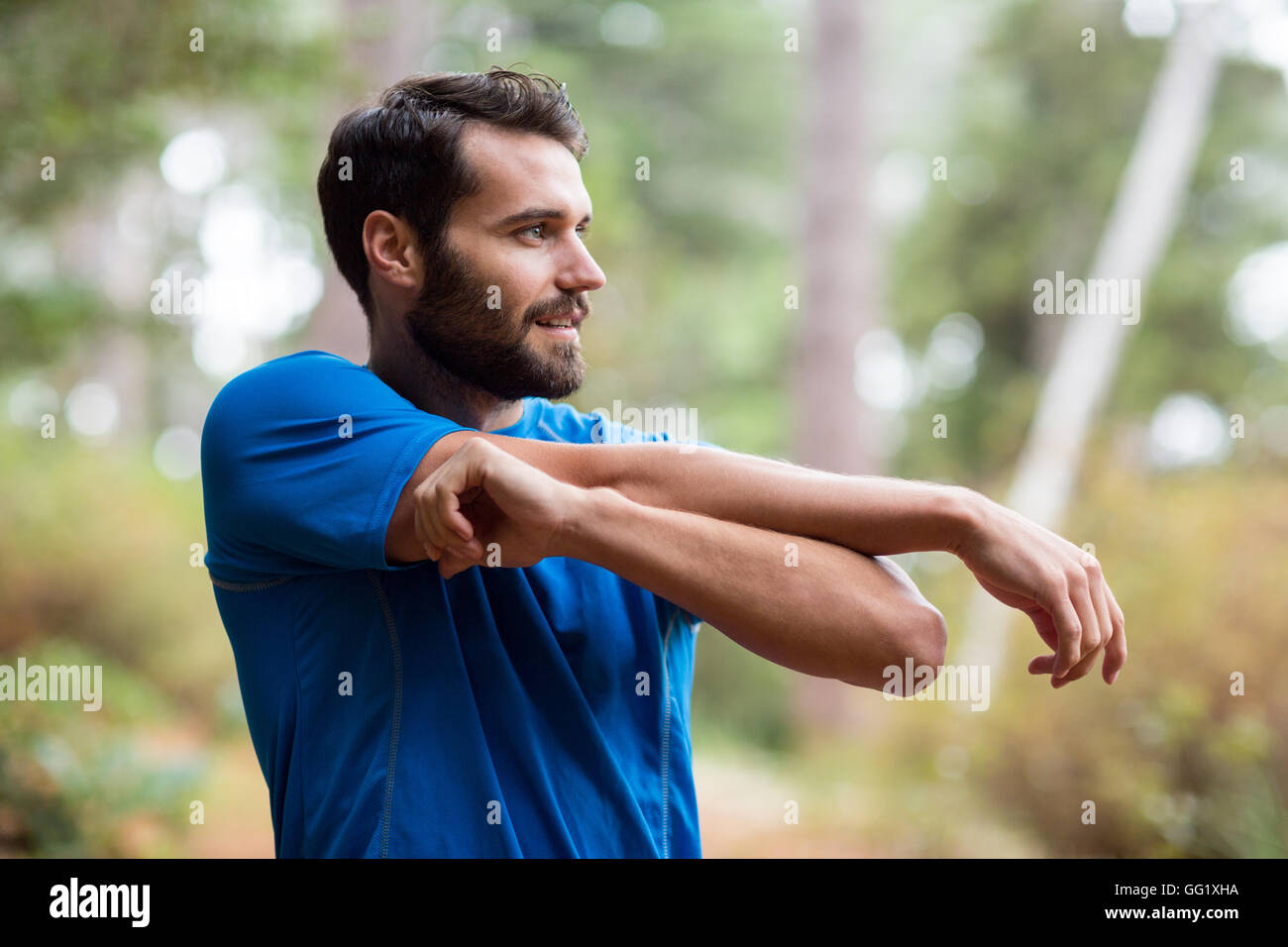 Handsome man stretching in forest hi-res stock photography and images ...