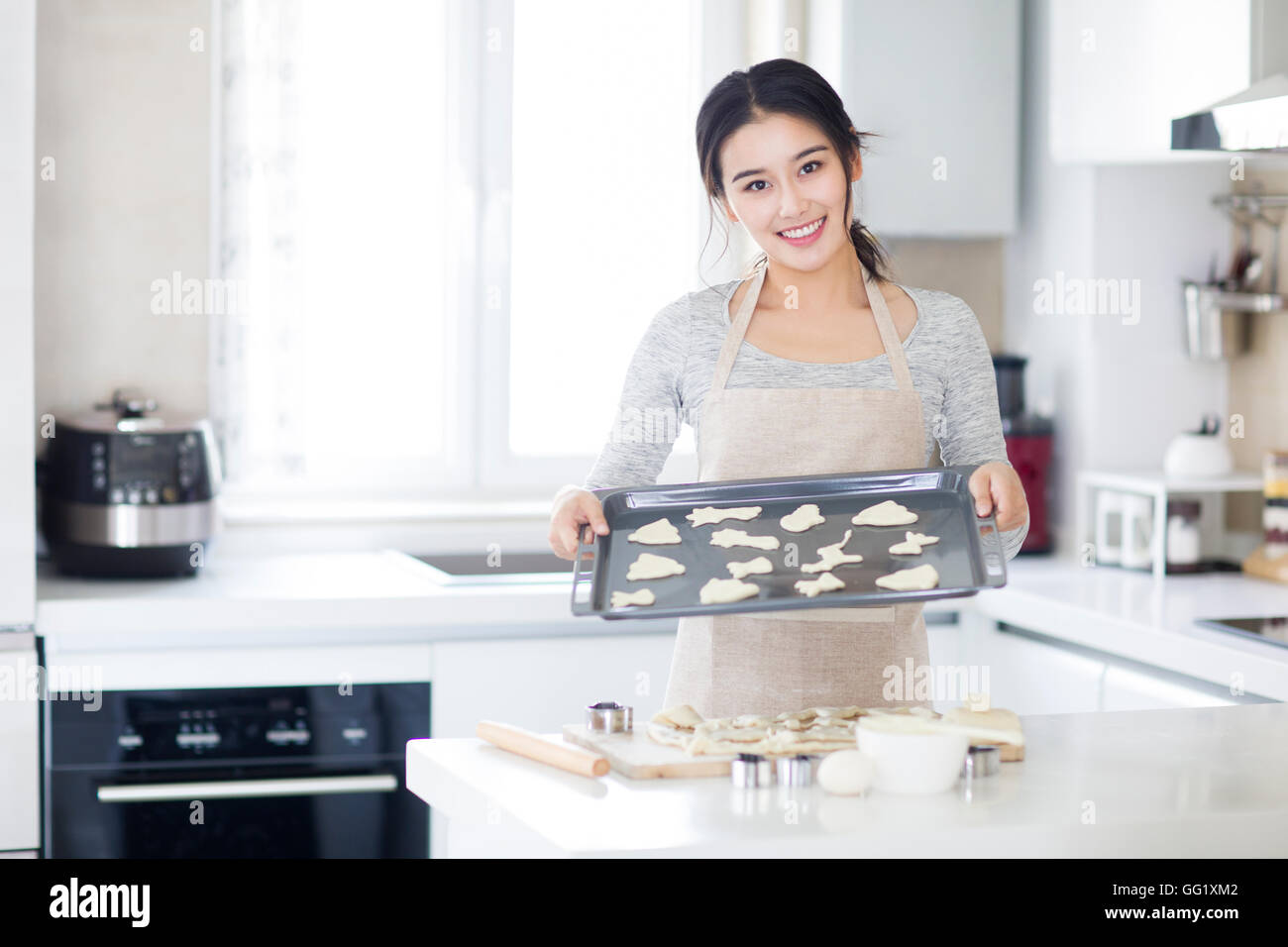 Young Chinese woman making cookies in kitchen Stock Photo - Alamy