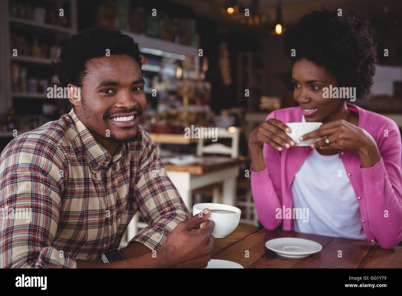 Young couple having coffee in cafeteria Stock Photo - Alamy