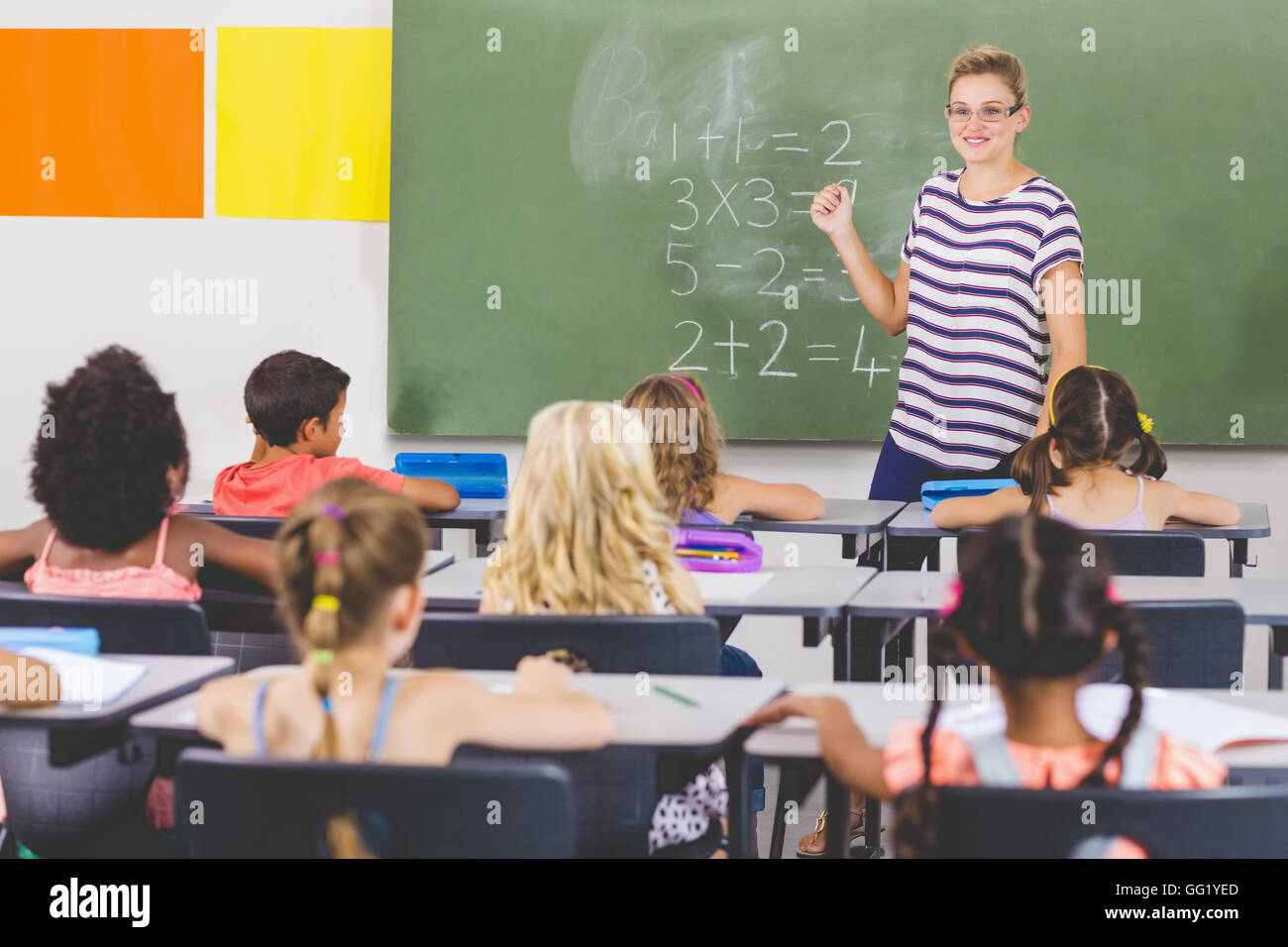 Teacher teaching mathematics to school kids in classroom Stock Photo ...