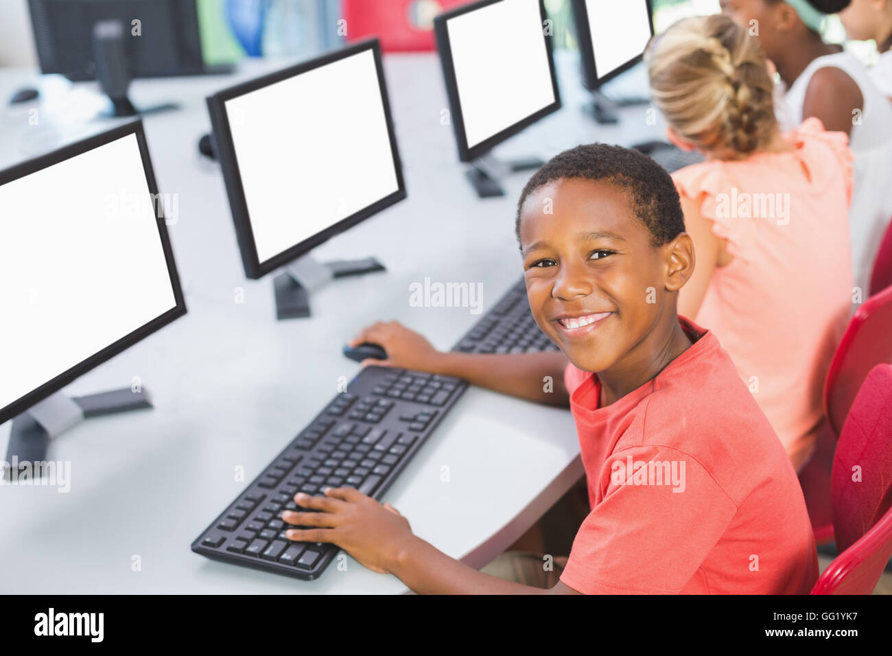 Schoolboy using computer in classroom Stock Photo - Alamy