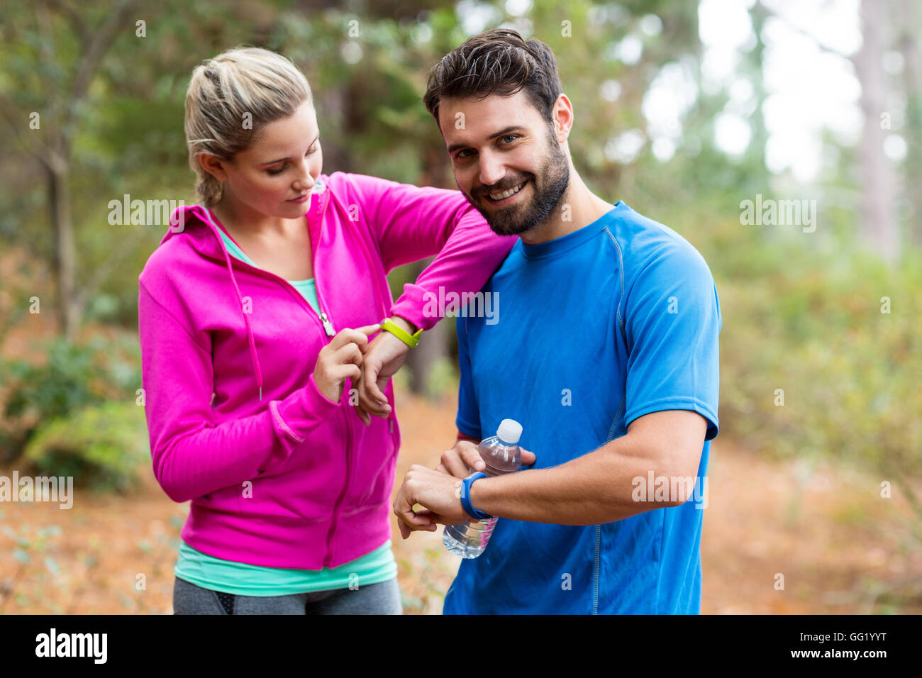 Athletic couple checking a time Stock Photo - Alamy