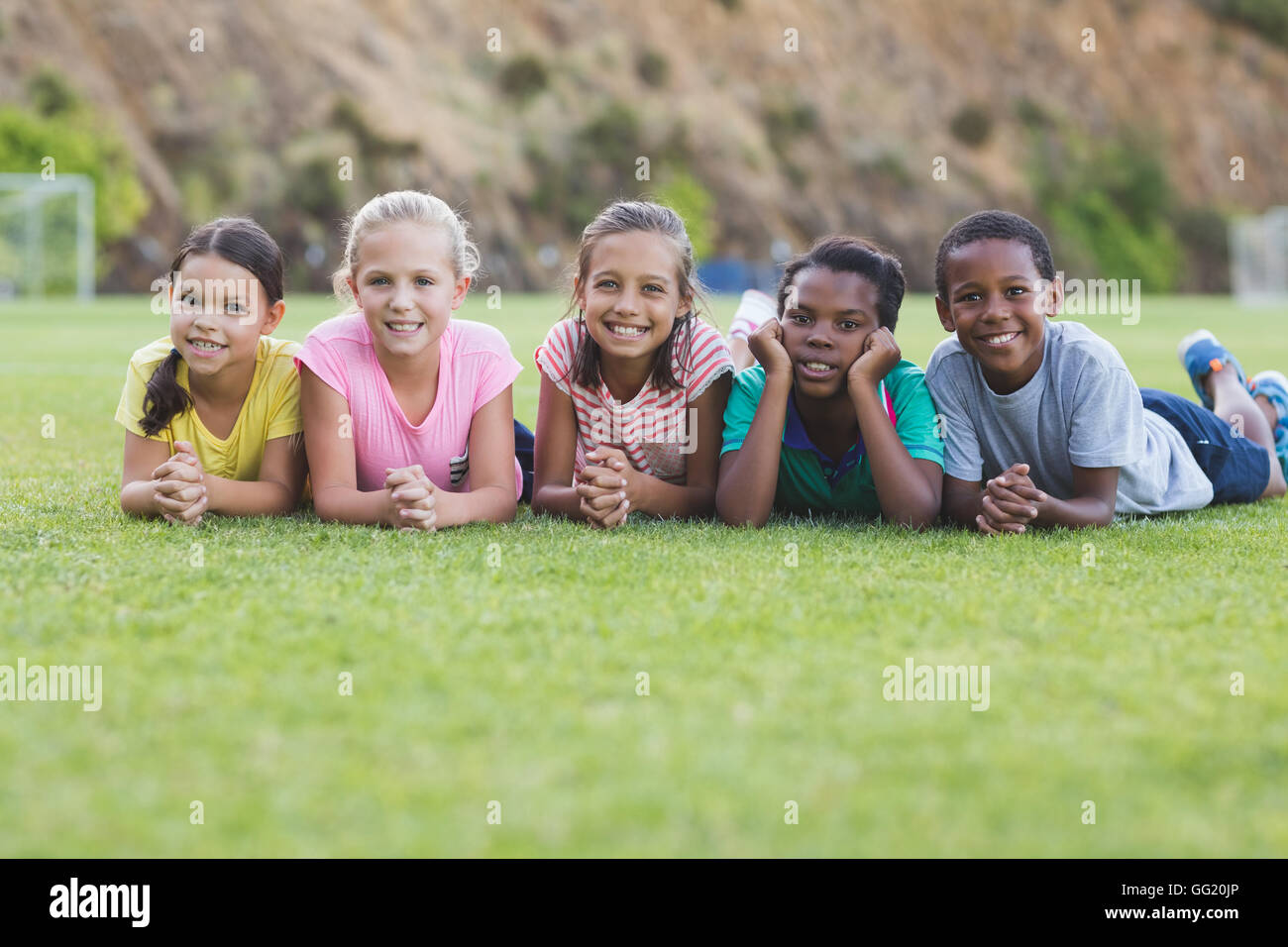 School kids lying on playground Stock Photo - Alamy